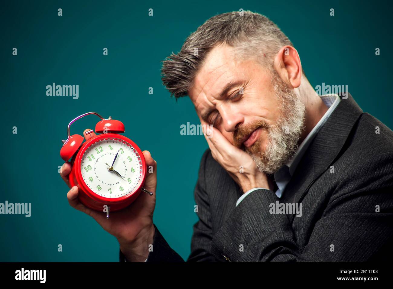 Bearded Businessman In Suit Holding Red Alarm Clock And Sleeping Time