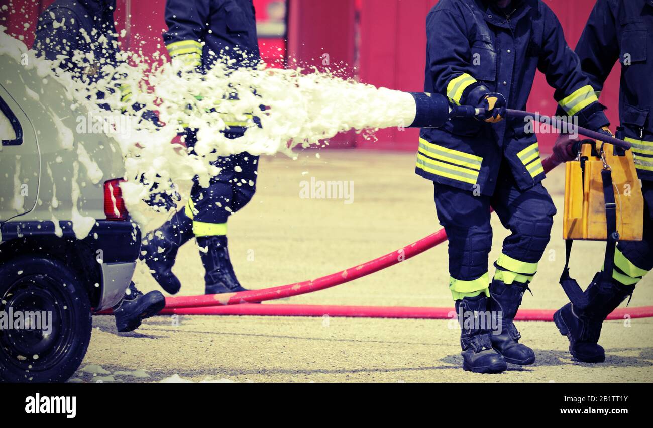 fireman with uniform helmet and respirator with oxygen cylinders during ...