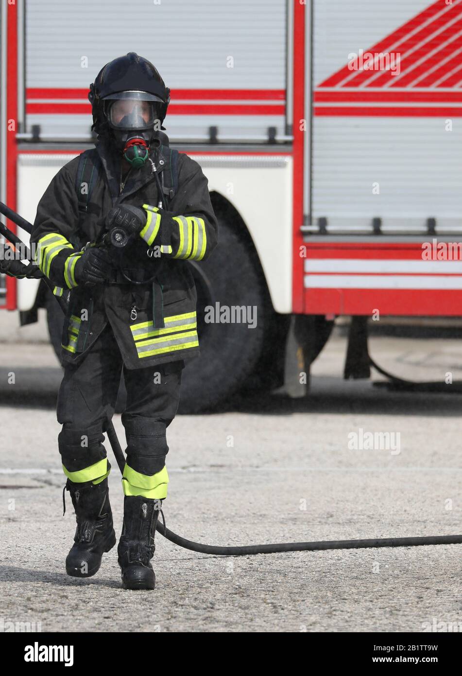 fireman with uniform and respirator with oxygen cylinders during ...