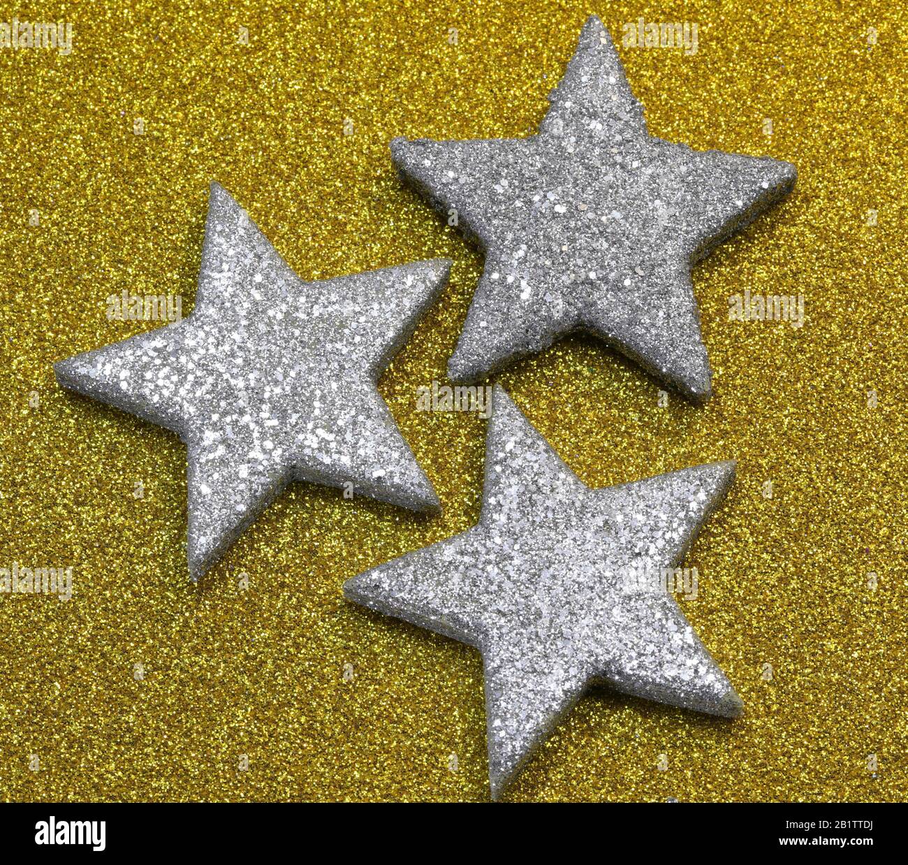 three big silver stars on golden GLITTER background Stock Photo - Alamy