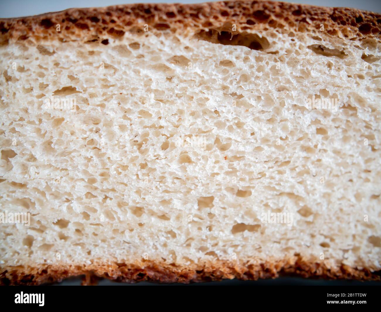 Porous white bread in the cut. Close-up Stock Photo - Alamy