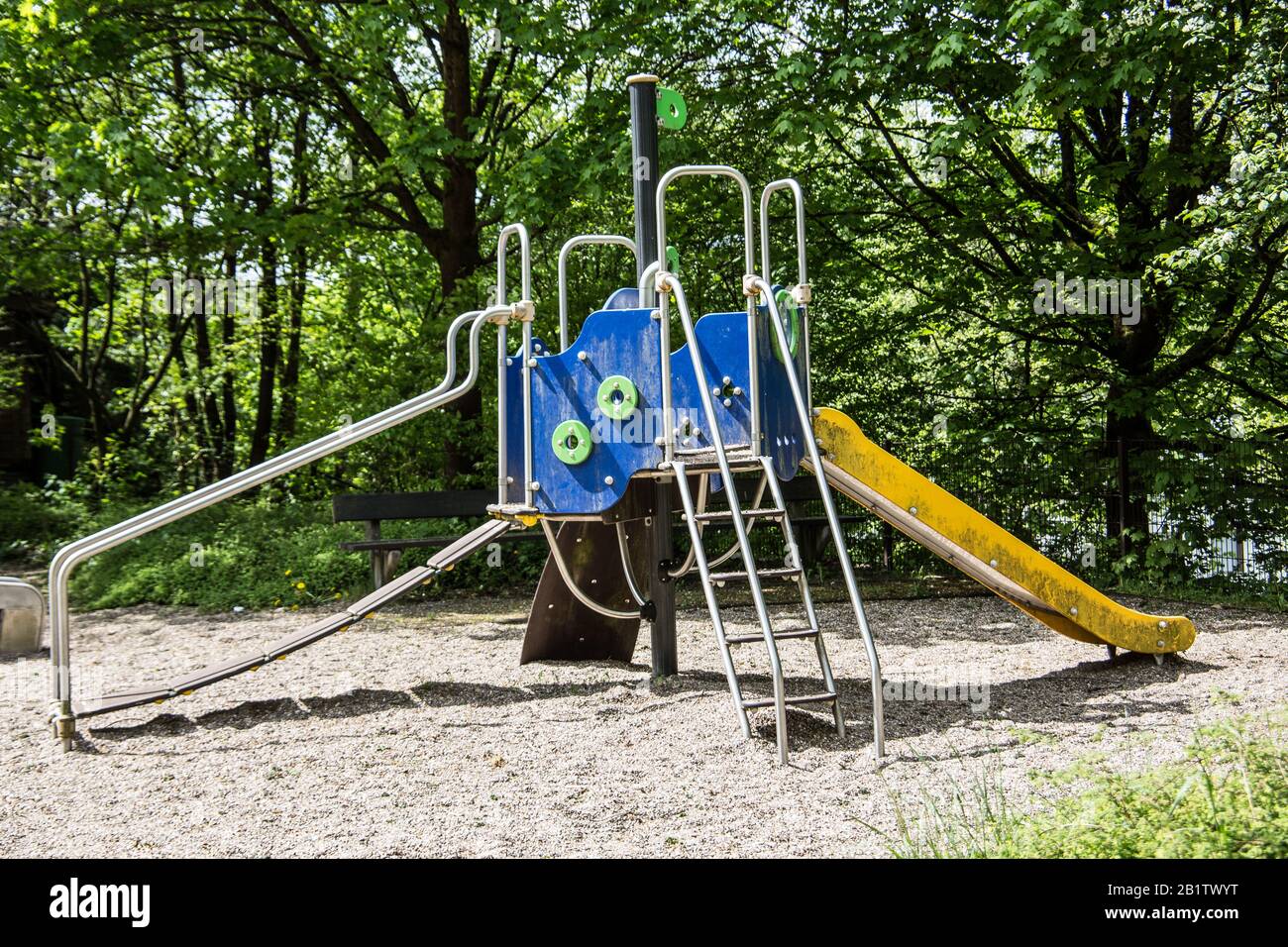 Adventure playground with slide and metal bars Stock Photo - Alamy