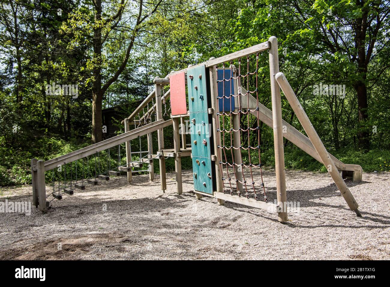 Adventure playground with slide and metal bars Stock Photo - Alamy