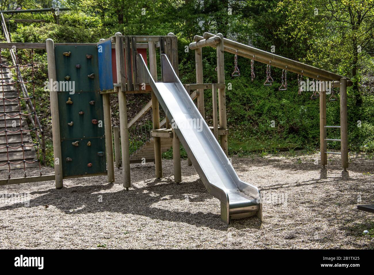 Adventure playground with slide and metal bars Stock Photo - Alamy