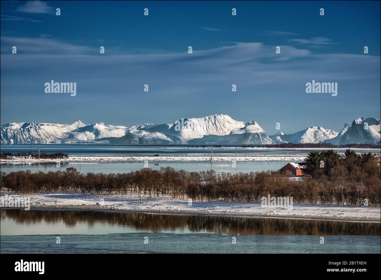 Snowscape in Norway with mountains, trees, water and a red barn Stock ...
