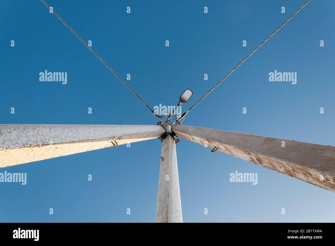 Electric pole on blue sky background in the light of the rising sun ...
