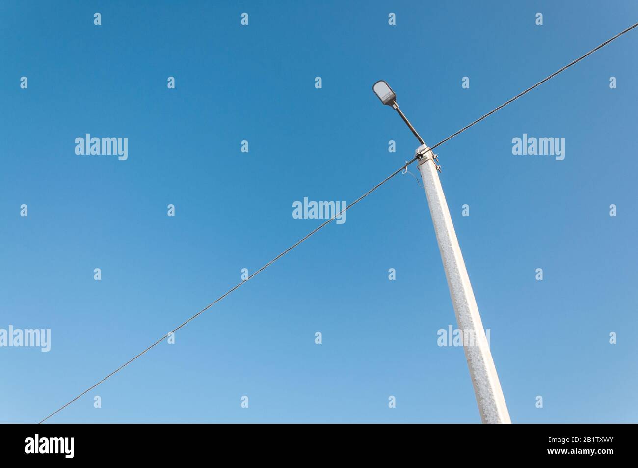 Electric pole on blue sky background in the light of the rising sun ...