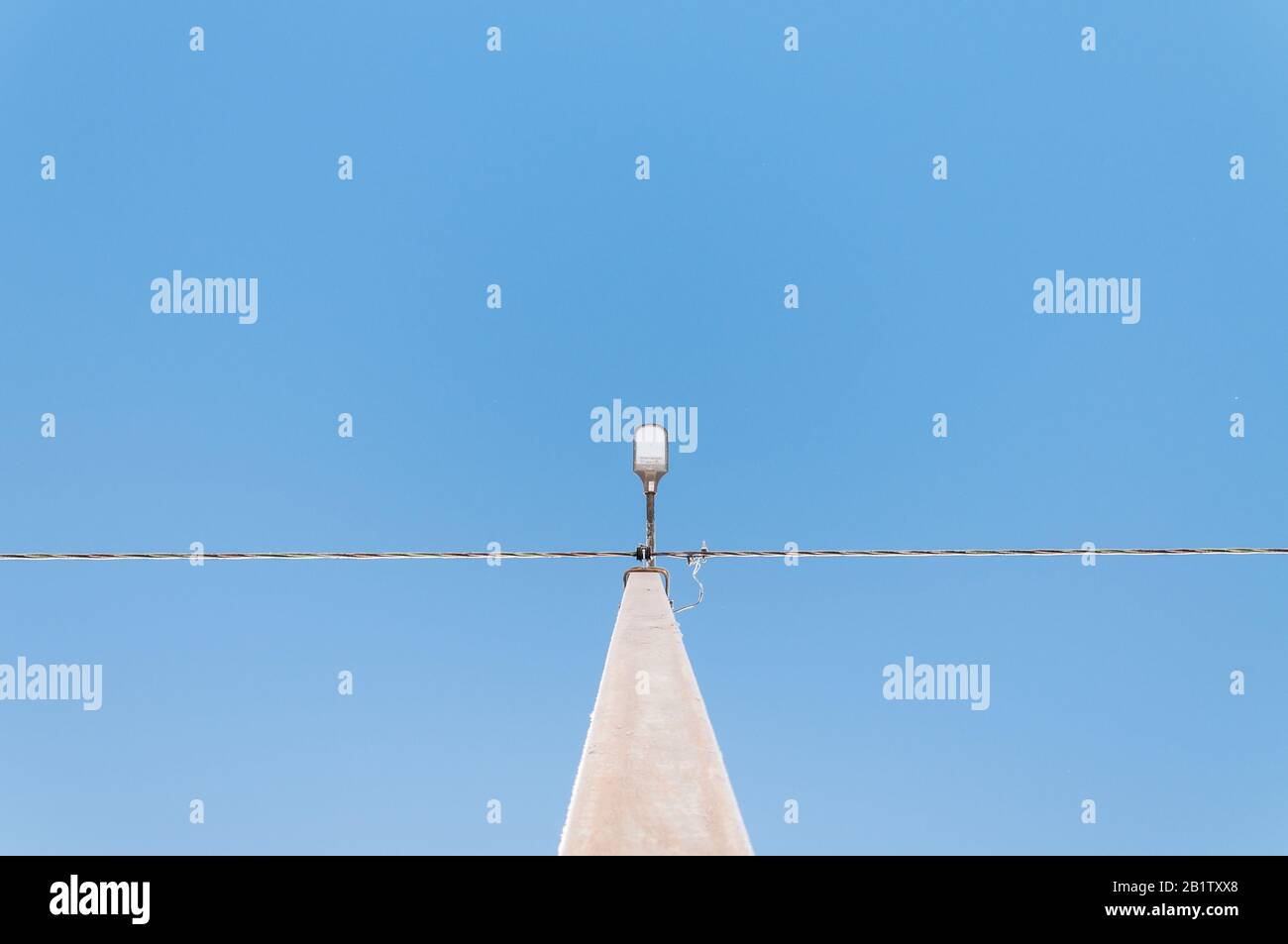 Electric pole on blue sky background in the light of the rising sun ...
