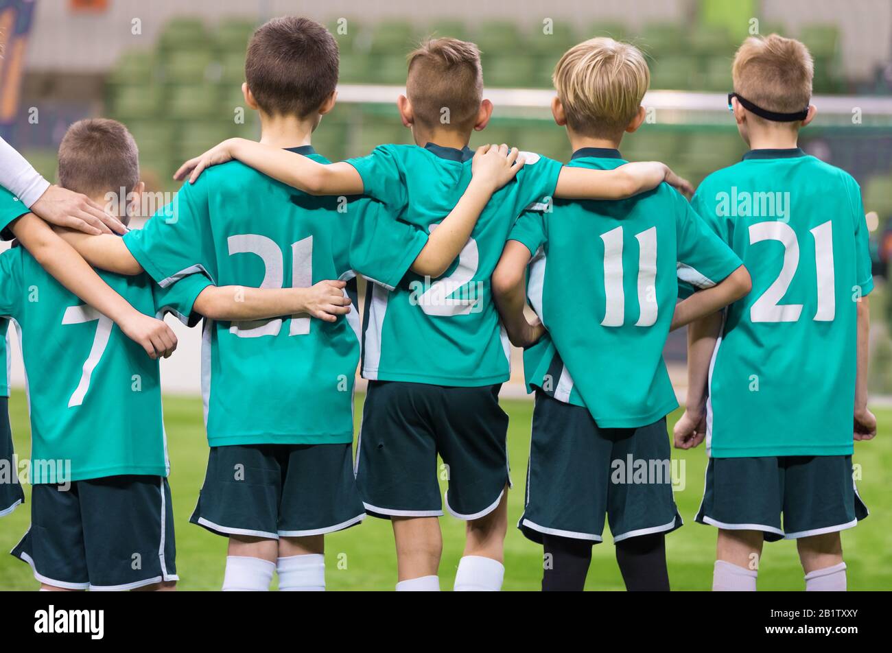 Team of young successful football players in spirts jersey uniform ...