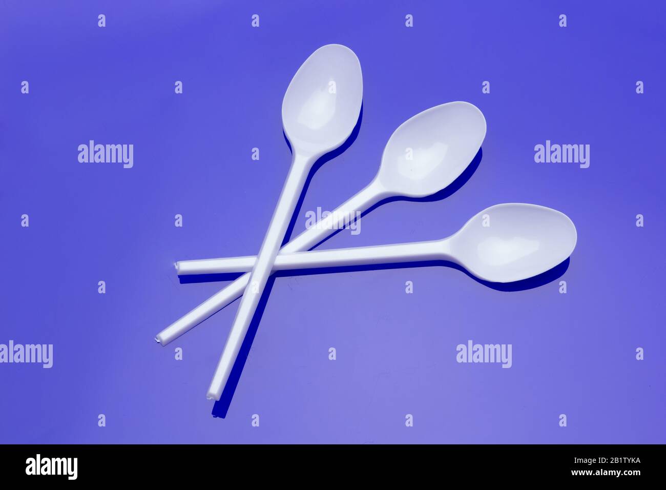 Small coffee spoon and plastic fork and white. Small objects used to ...