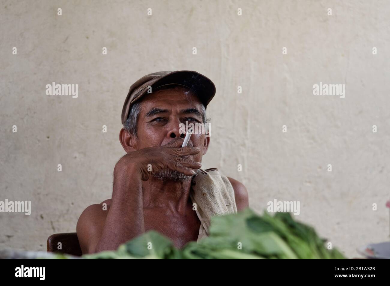 Indonesian man smoking on market at Glodok, the Chinese neighborhood in ...