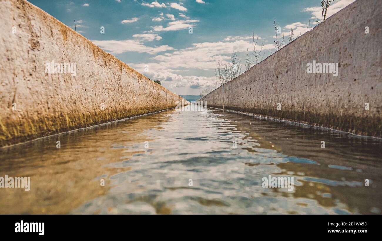 long line of straight canal with water Stock Photo - Alamy