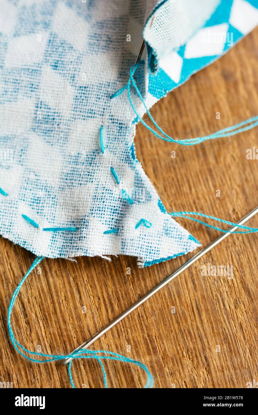 Sewing together two fabric parts of a soft toy Stock Photo - Alamy