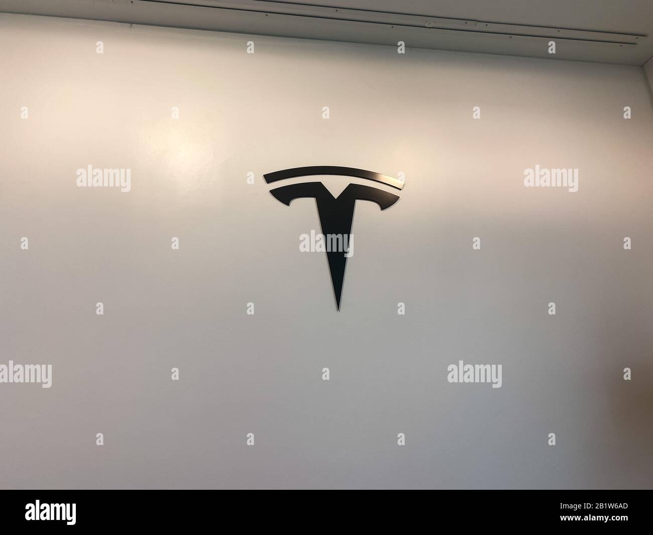 Orlando, FL/USA-2/17/20: The Tesla logo on the wall at a Tesla retail ...