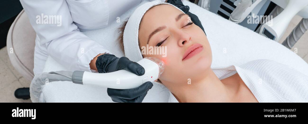 Young woman receiving laser treatment Stock Photo - Alamy