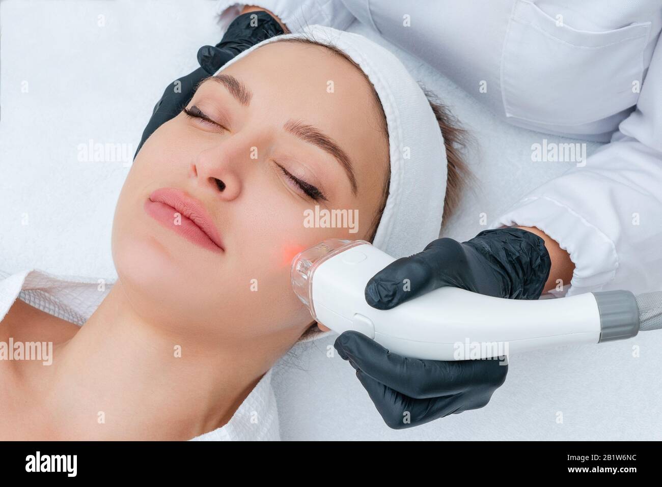 Young woman receiving laser treatment Stock Photo - Alamy