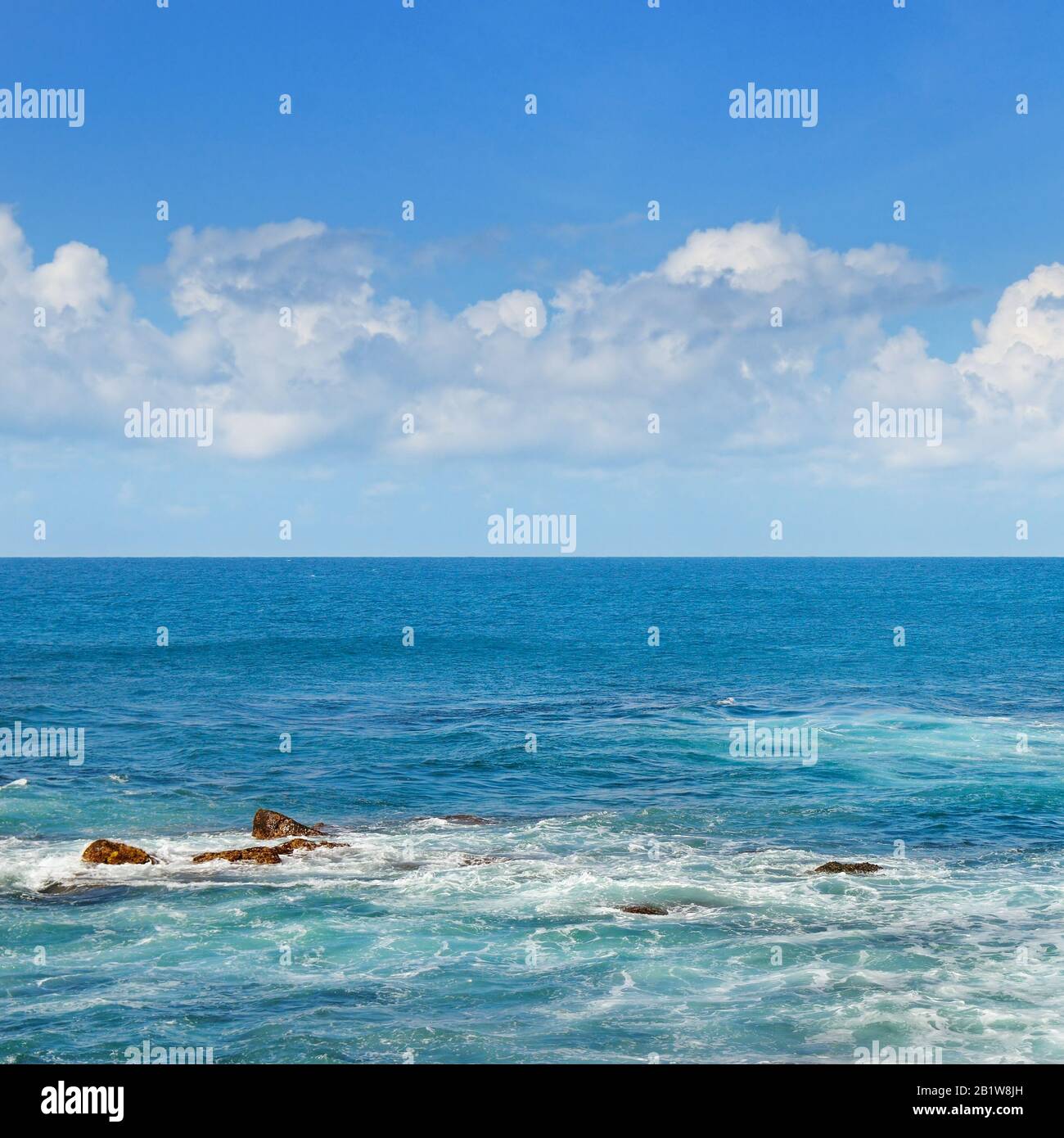 Tropical ocean, beach, high waves and blue sky Stock Photo - Alamy