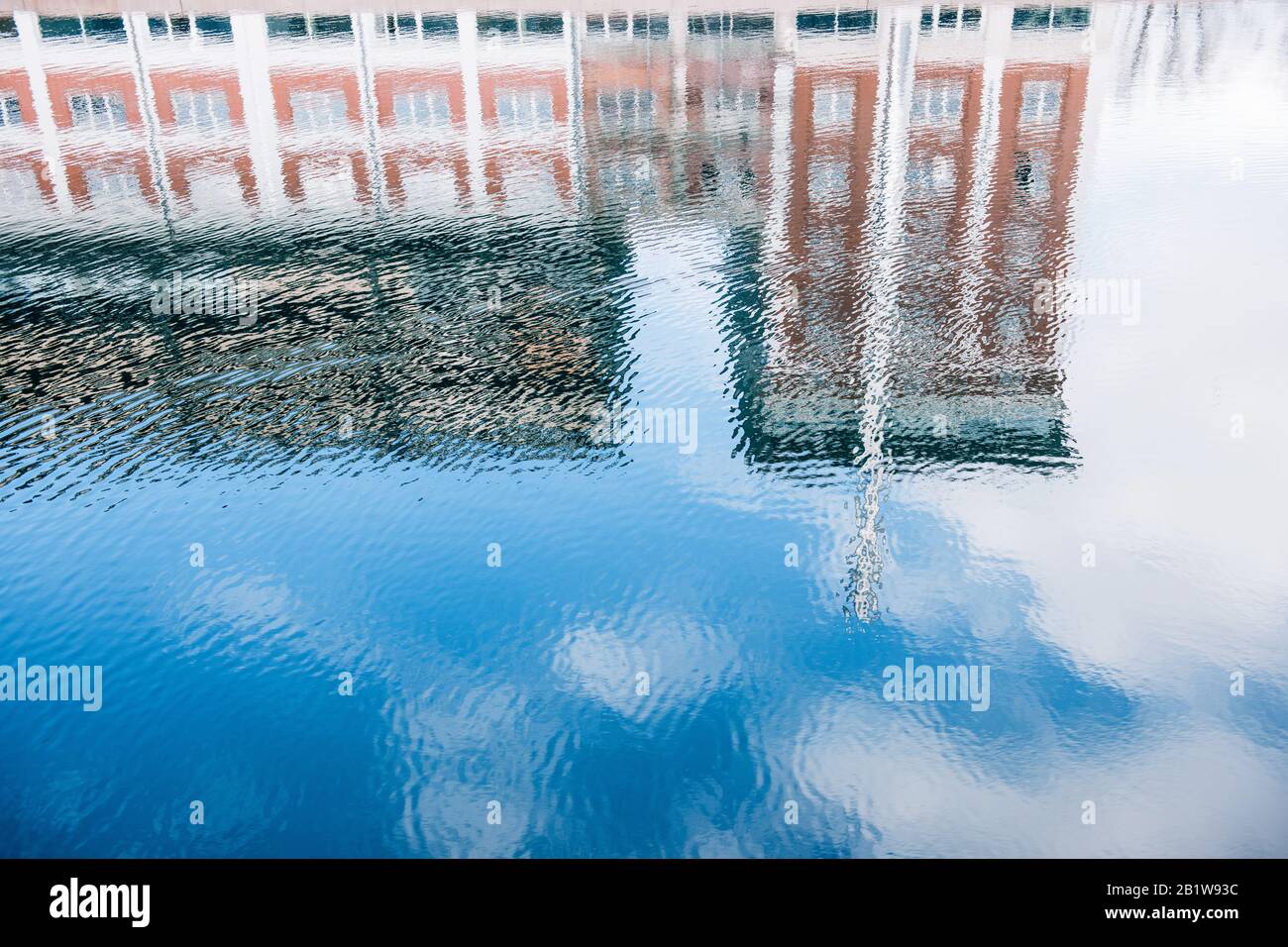 Inverted reflection of beautiful building in water canal abstract image ...