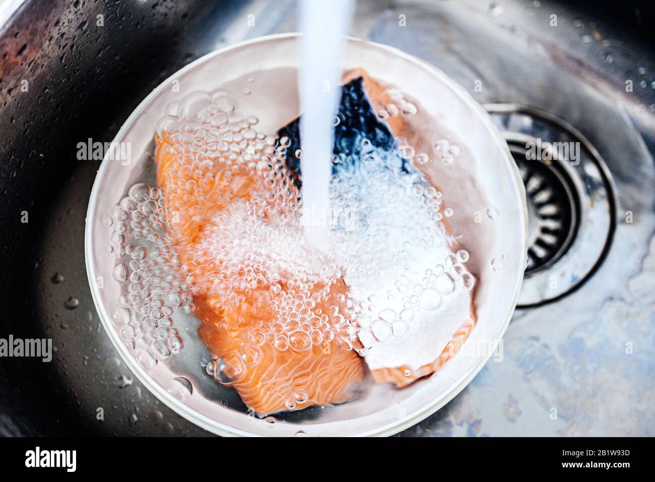 Water pouring washing inside kitchen stainless steel sink with plastic ...