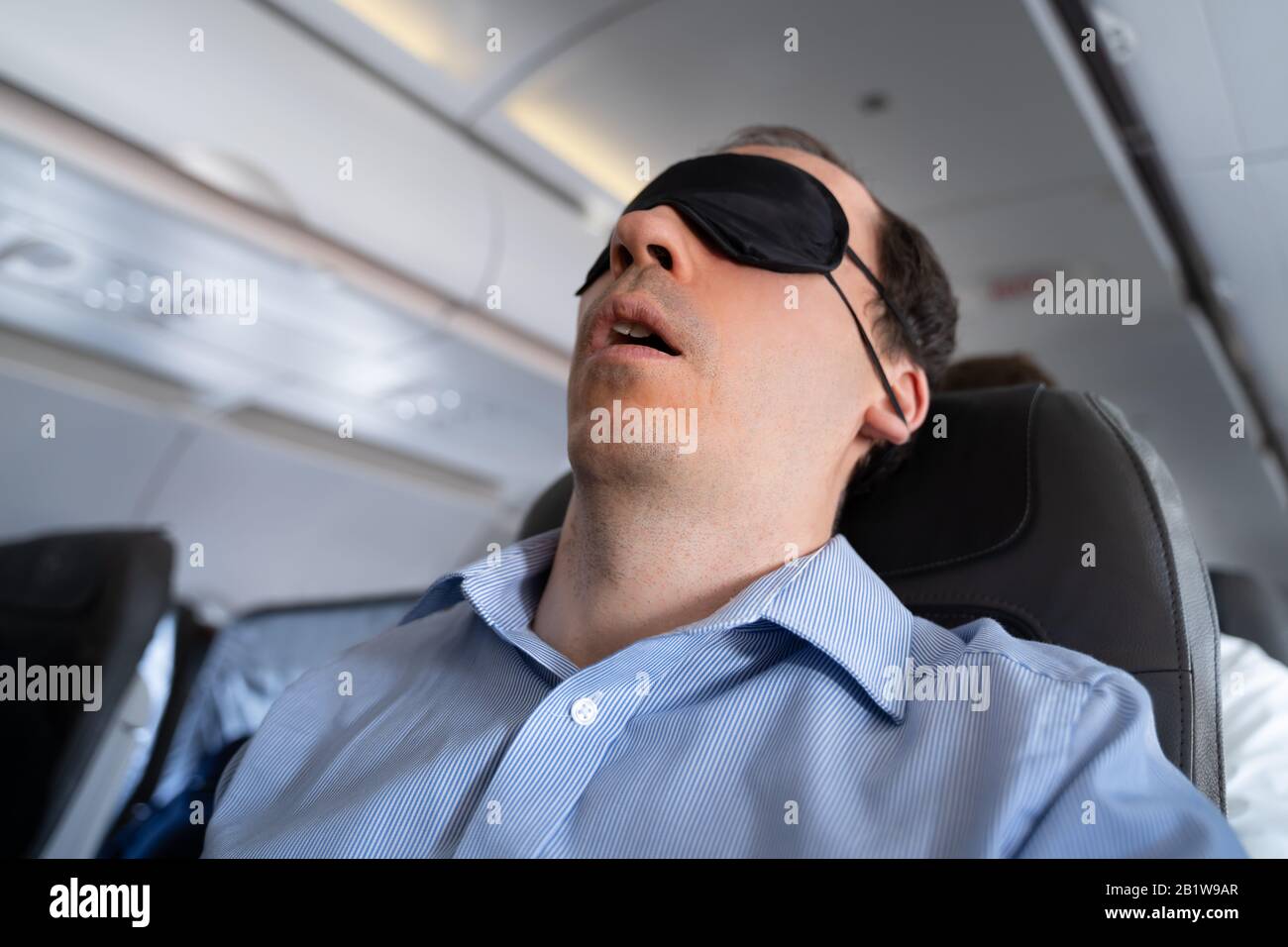 Sleep on plane hi-res stock photography and images - Alamy