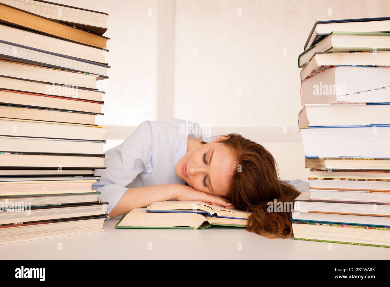 Tired girl sleeping on books hi-res stock photography and images - Alamy