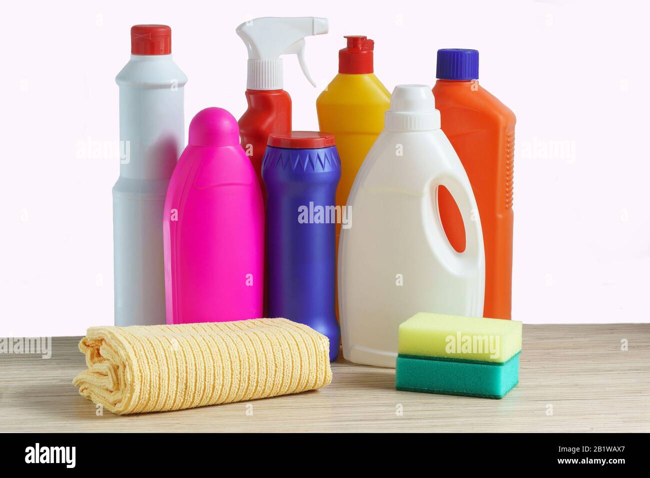 Colorful bottles of cleaning products, sponge and rag for cleaning the ...