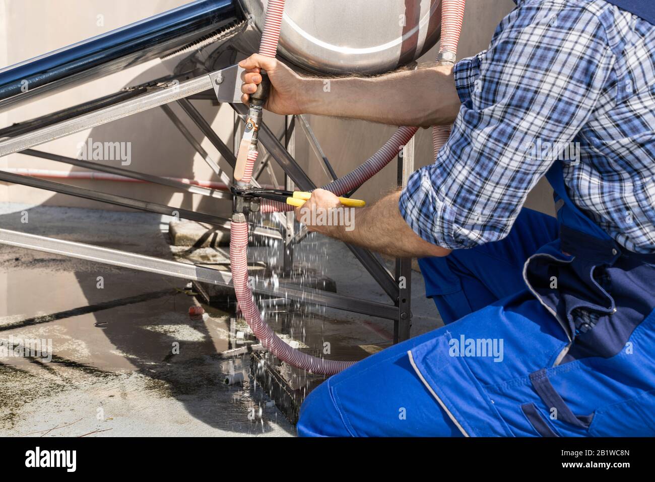 Man repairing leaking pipe hi-res stock photography and images - Alamy