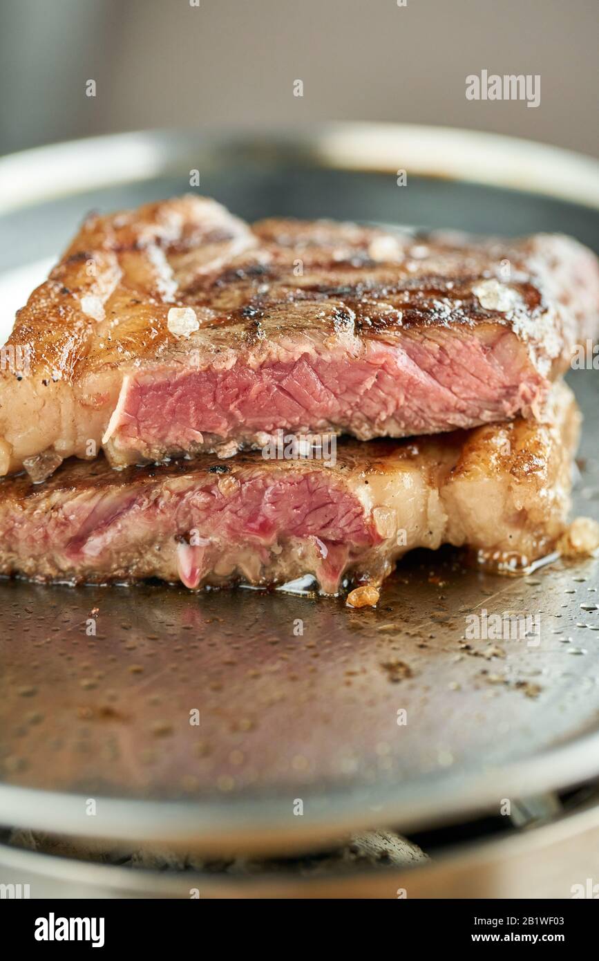 Metal Plate on red coal with Grilled striploin steak . The strip steak ...