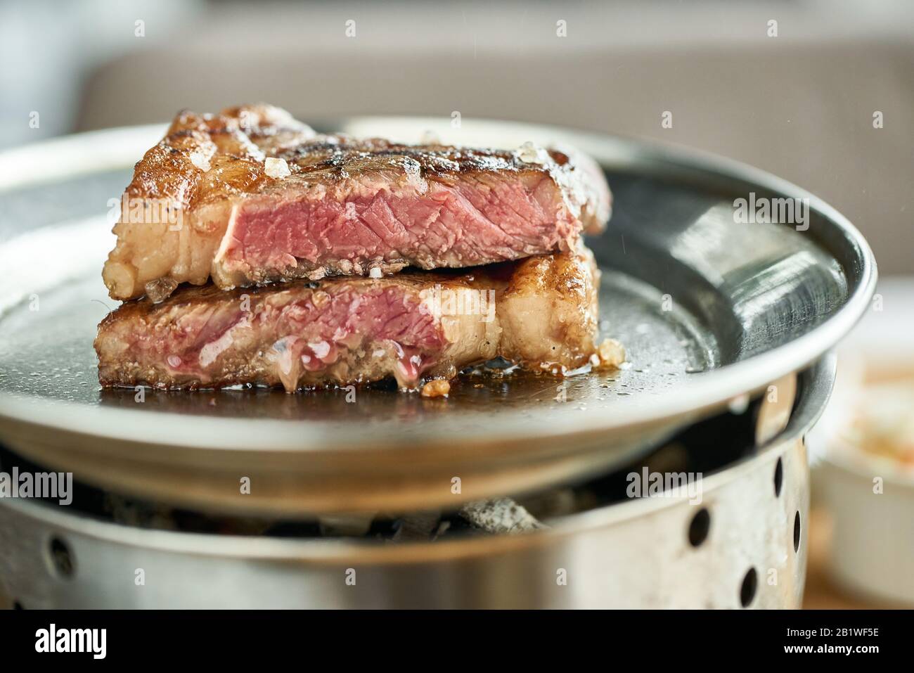 Metal Plate on red coal with Grilled striploin steak . The strip steak ...