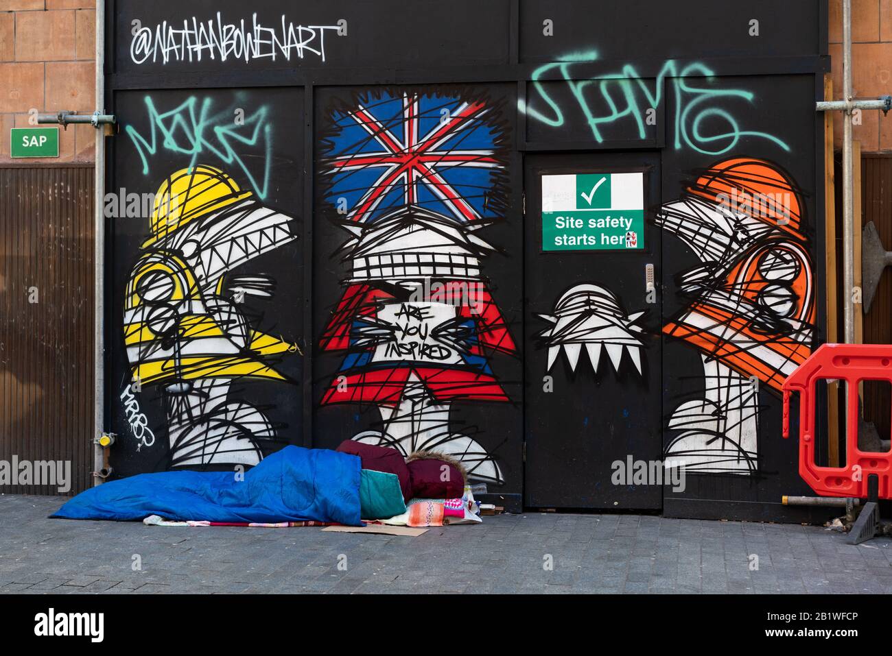 Homeless person sleeping rough in central London. Colourful artwork and ...