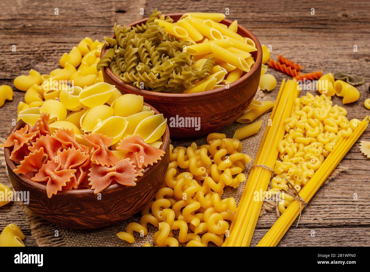 Different types of pasta in ceramic bowls. Traditional Italian food ...