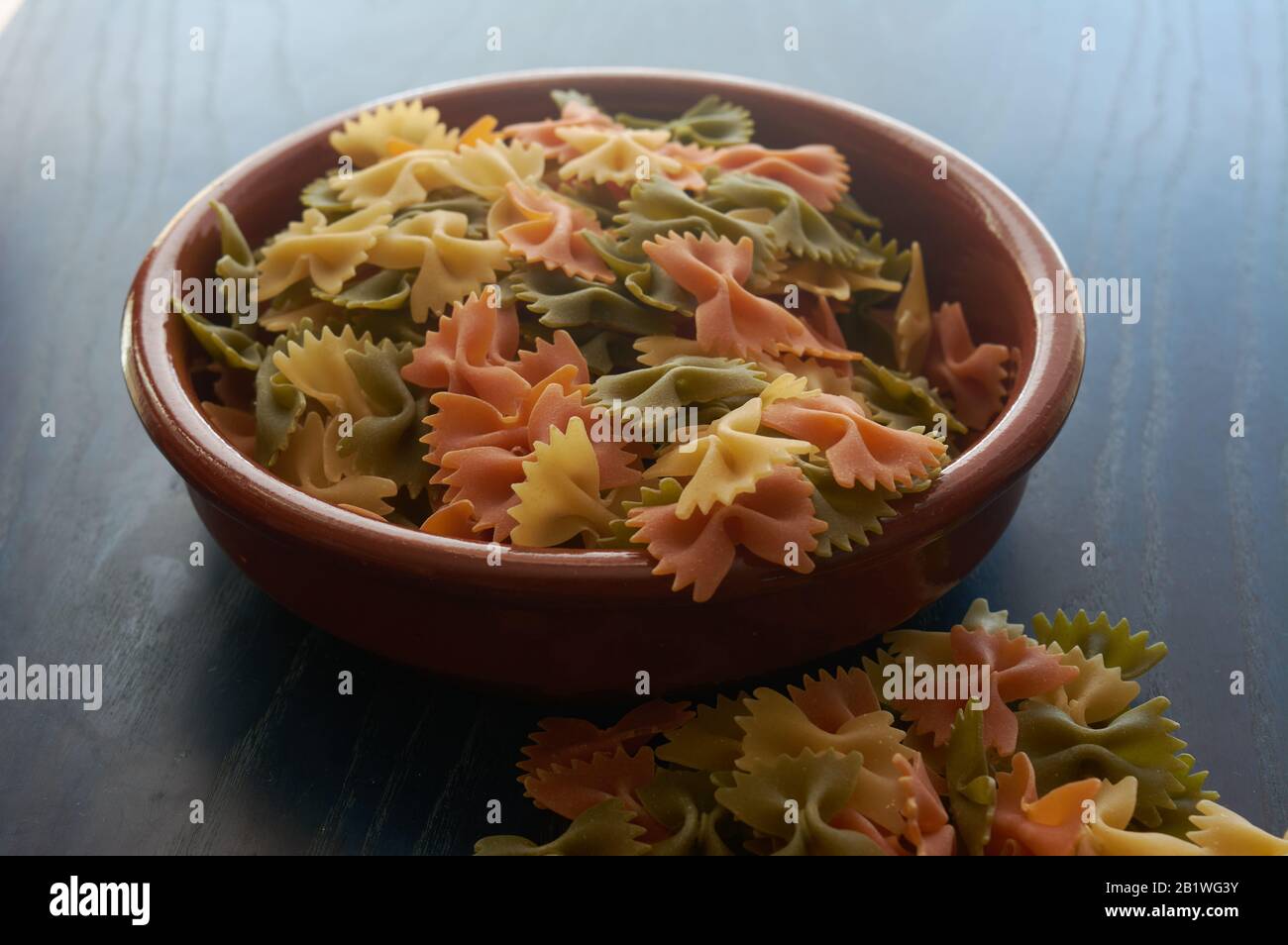 loop pasta, bright natural colors, basil green and red tomatoes, with ...