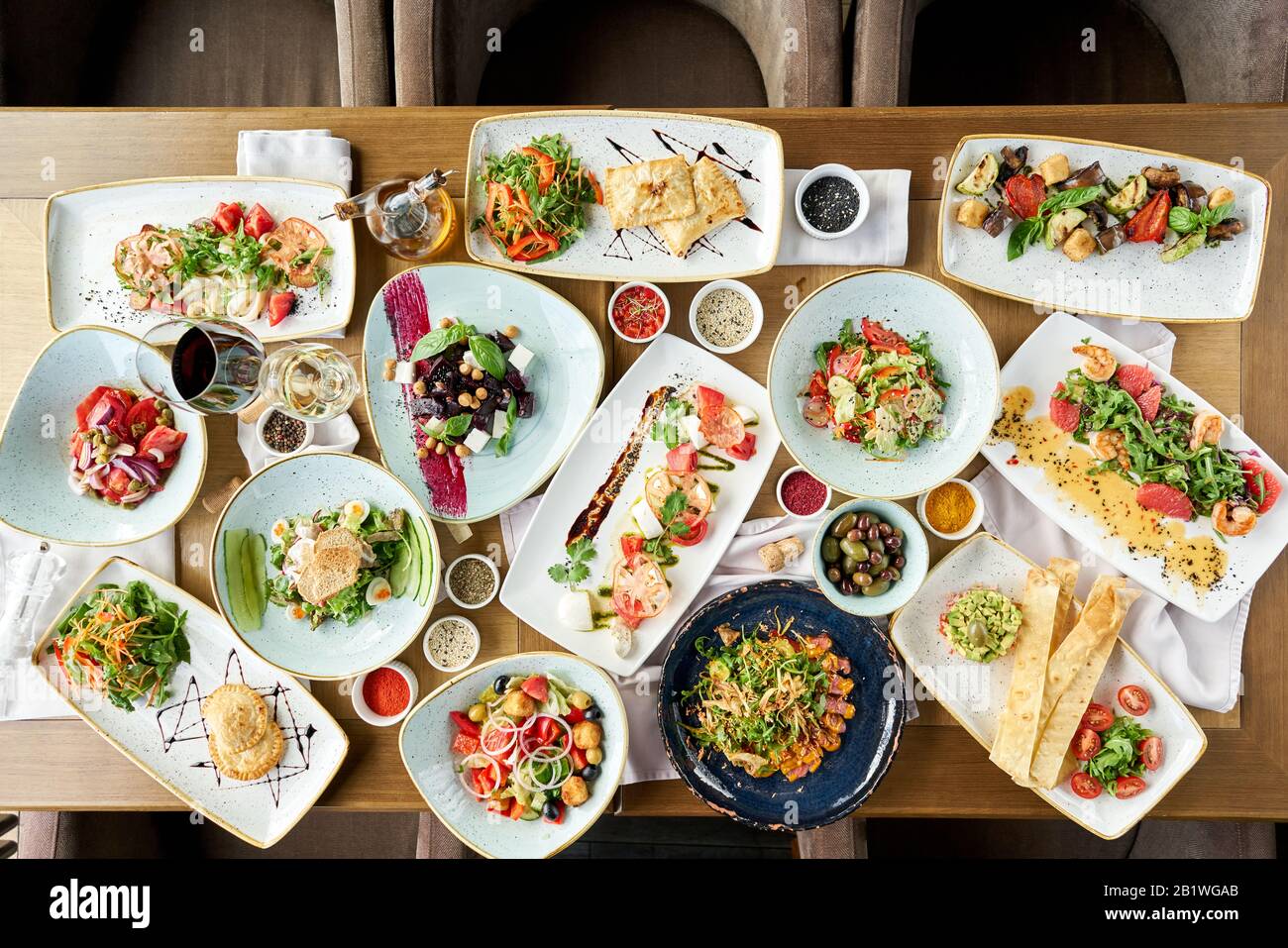 Many different delicious dishes dishes on the table. Various snacks and ...