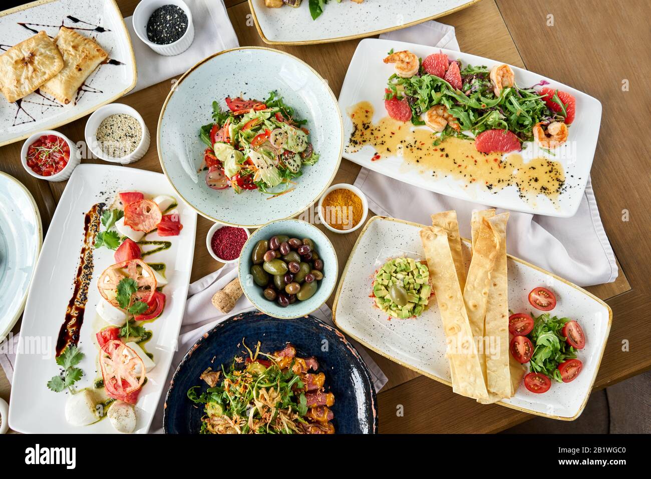 Many different delicious dishes dishes on the table. Various snacks and ...