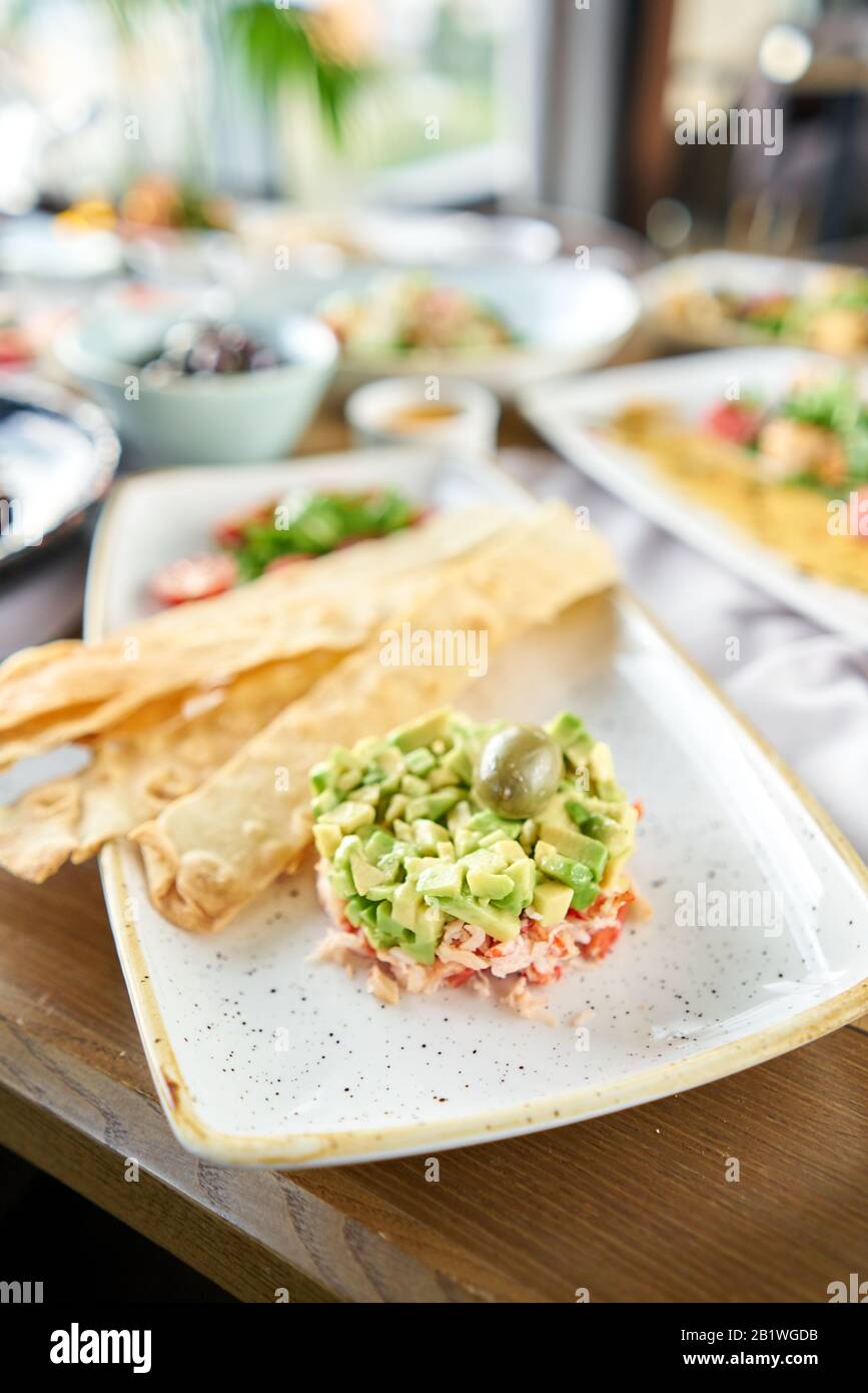 Salad crab, avocado, citrus oil, spices. Crab meat with matzo on white ...