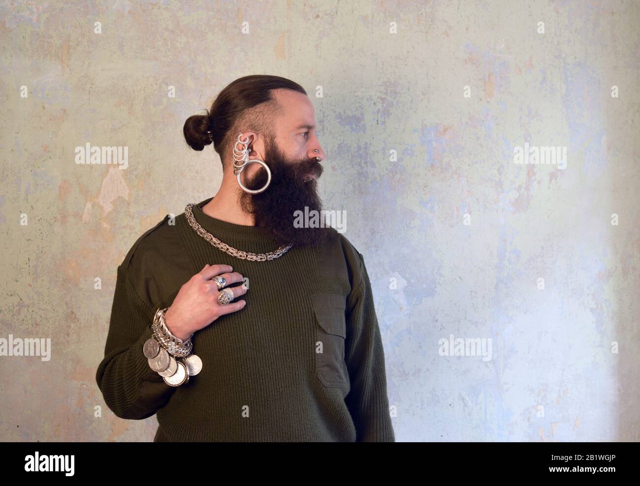 Male with longer hairs, huge beard, with piercings and tunnel in the ...