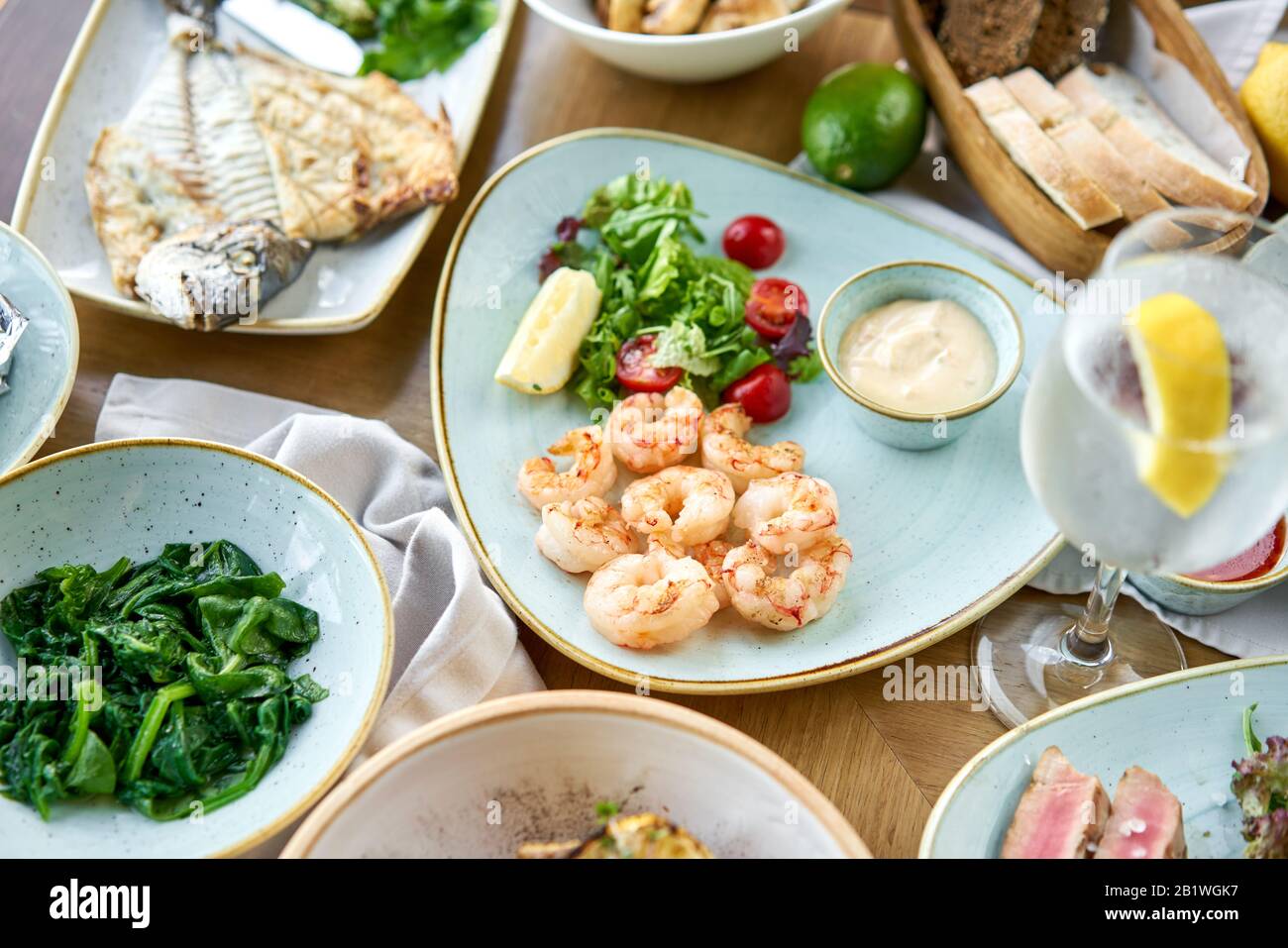 Many different delicious dishes dishes on the table. Various snacks and ...