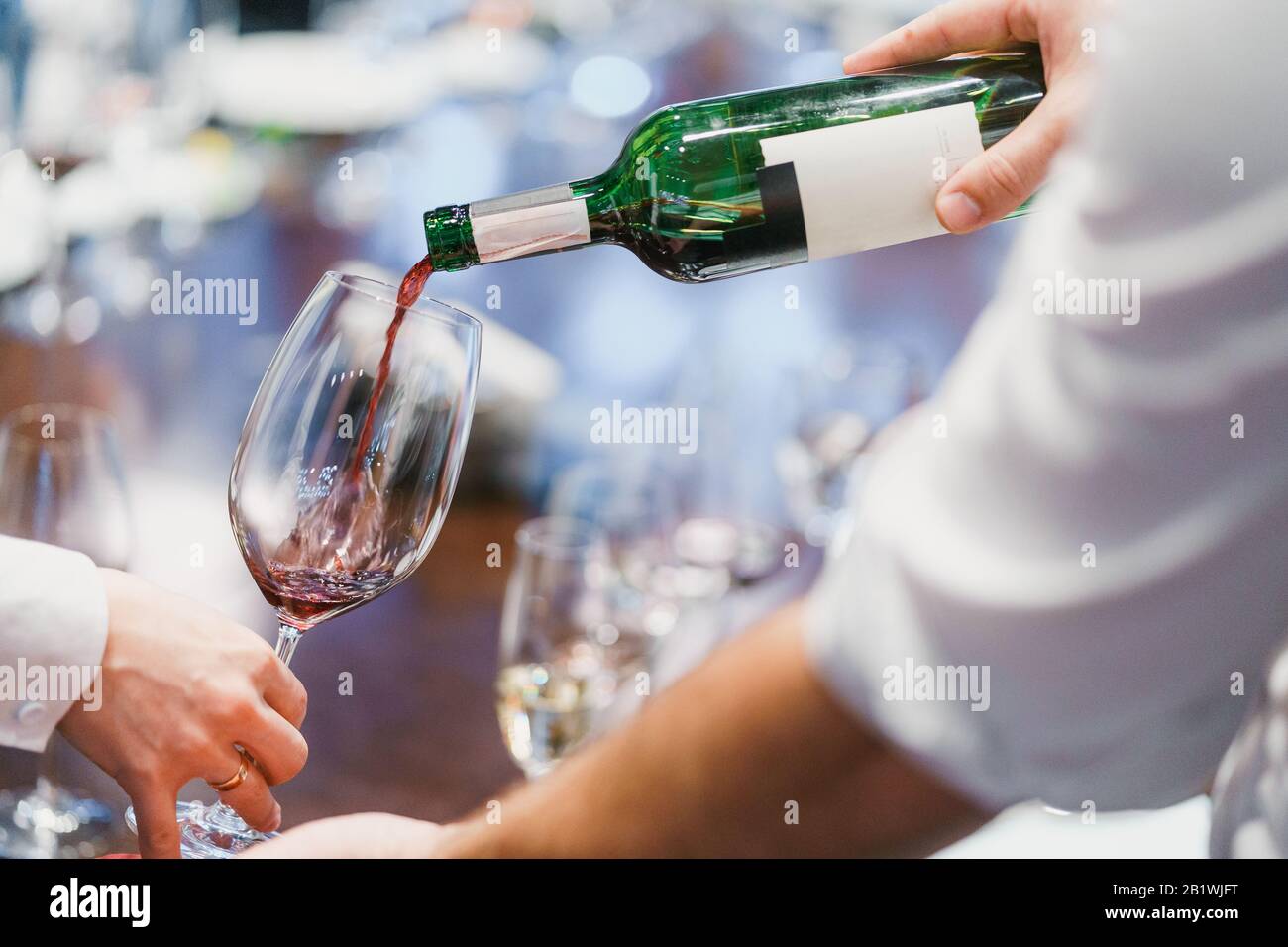 Waiter serve wine glass bottle hi-res stock photography and images - Alamy