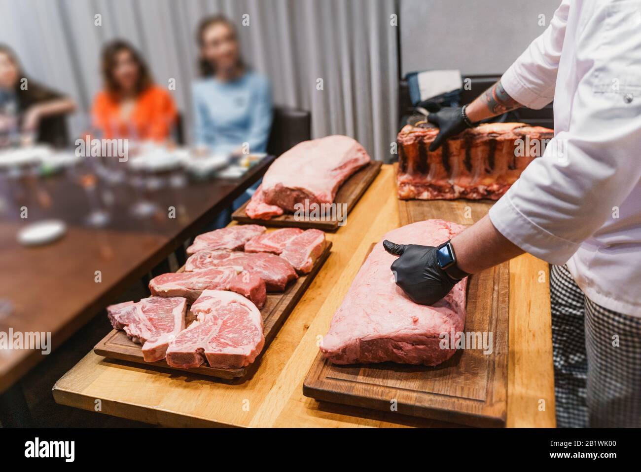 Chef presenting various types of gourmet meat to the visitors Stock ...