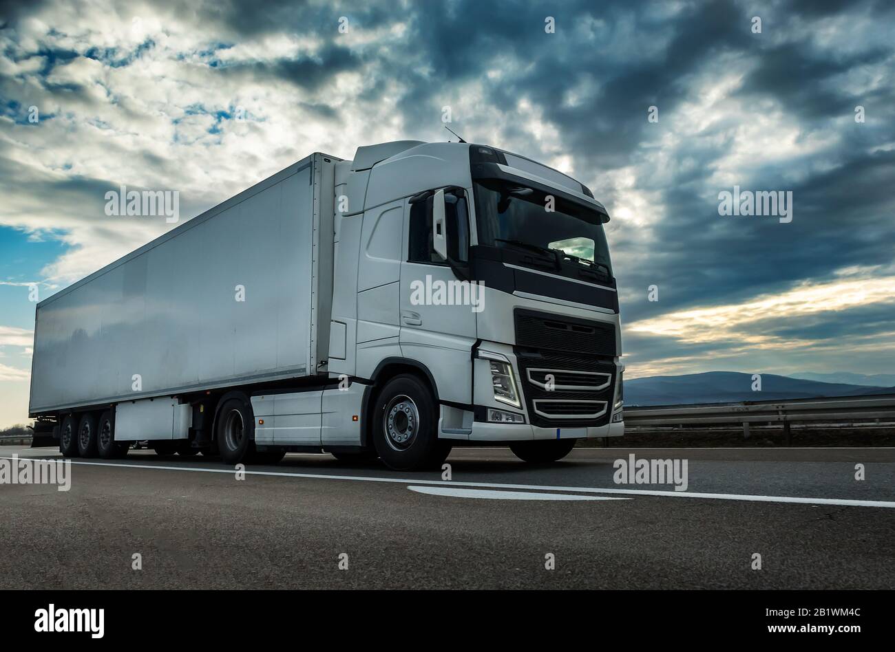 White semi trailer lorry truck on a highway driving at beautiful ...