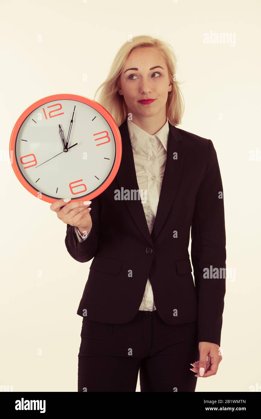 attractive business woman showing big round clock as a symbol of time ...