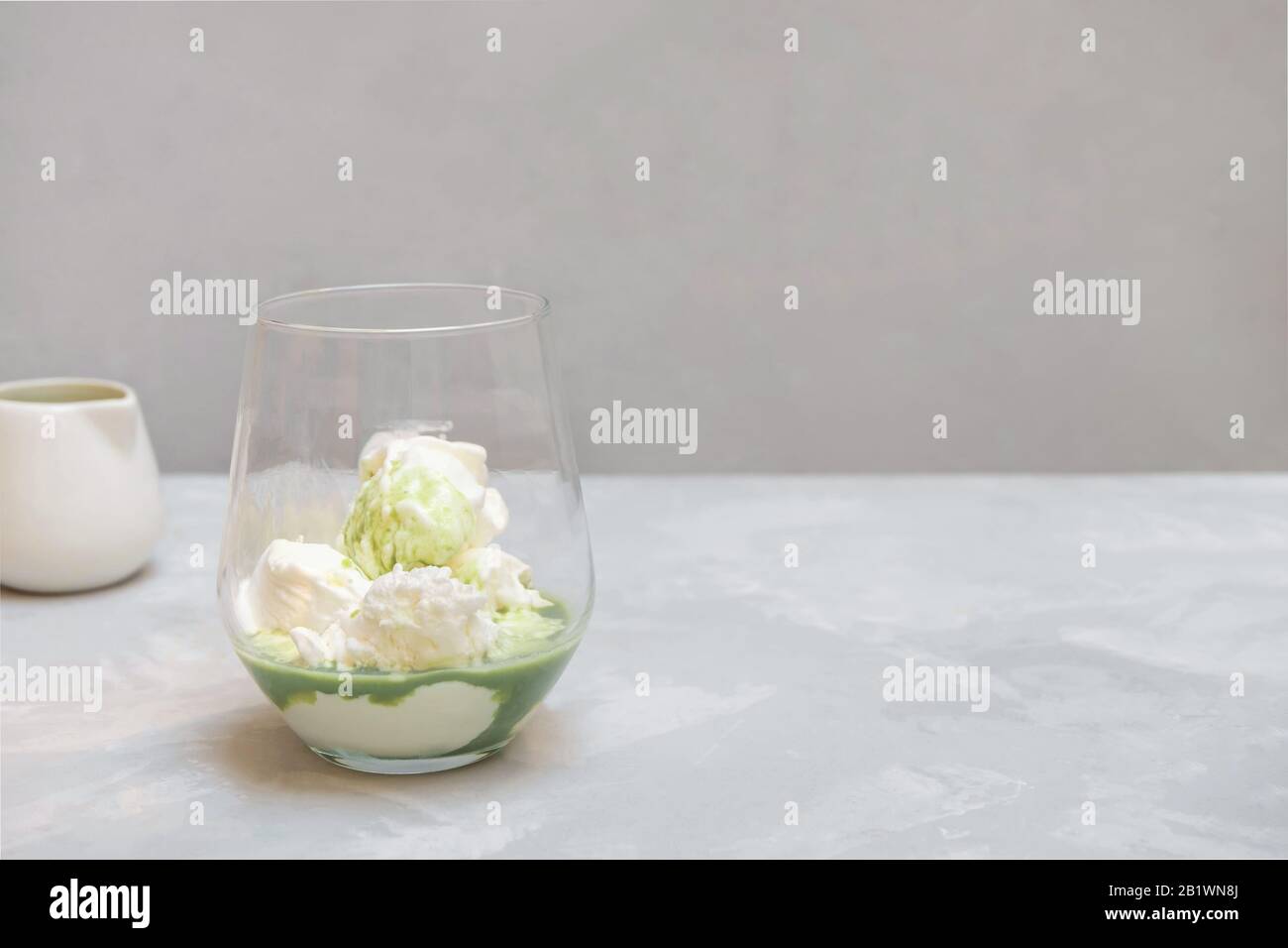 Matcha (green tea) affogato dessert on neutral grey background with ...