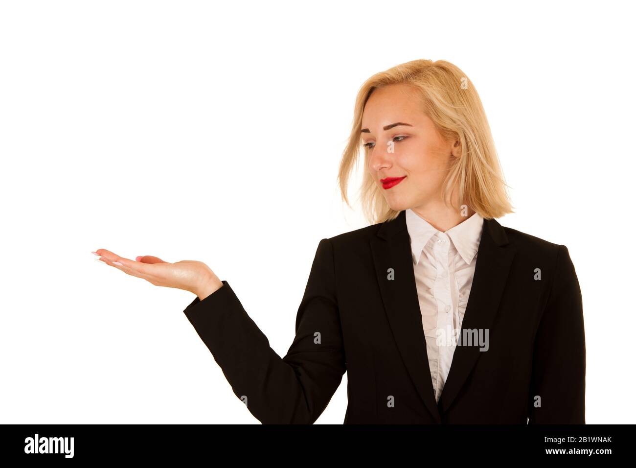 Attractive young woman point into copy space as she is holding an ...