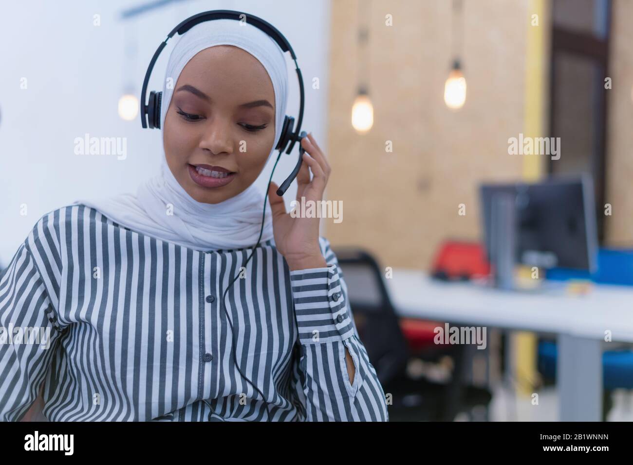 Happy african muslim woman in call center. Female Customer Service ...