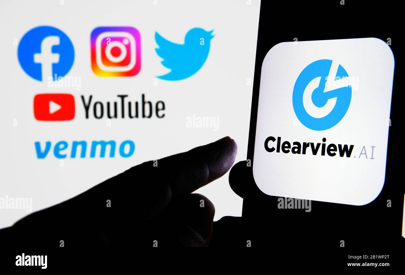 Clearview AI company logo on the smartphone hold in hands with blurred ...