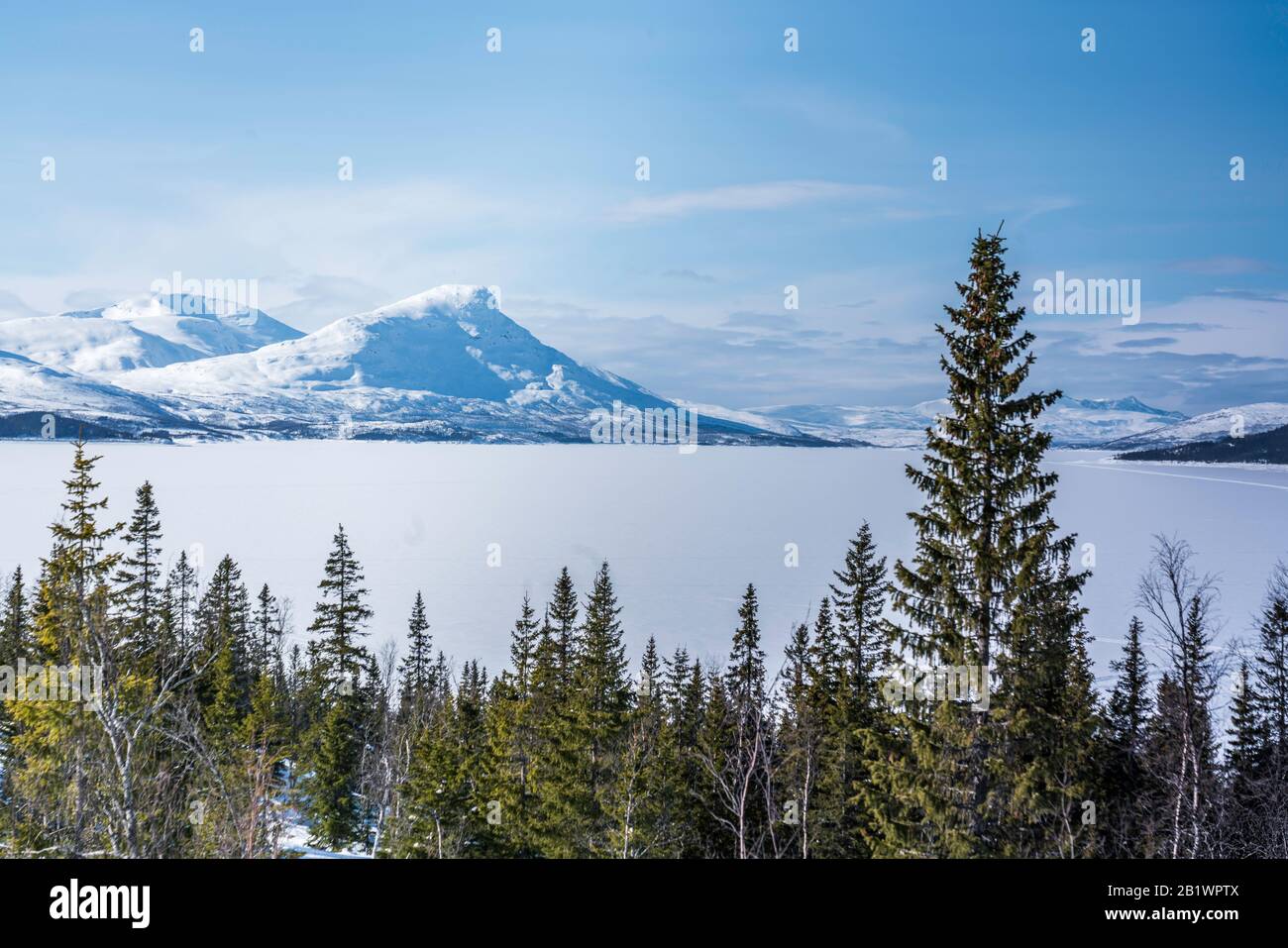 Scandinavian mountain range covered by ice and snow, frozen lake, blue ...
