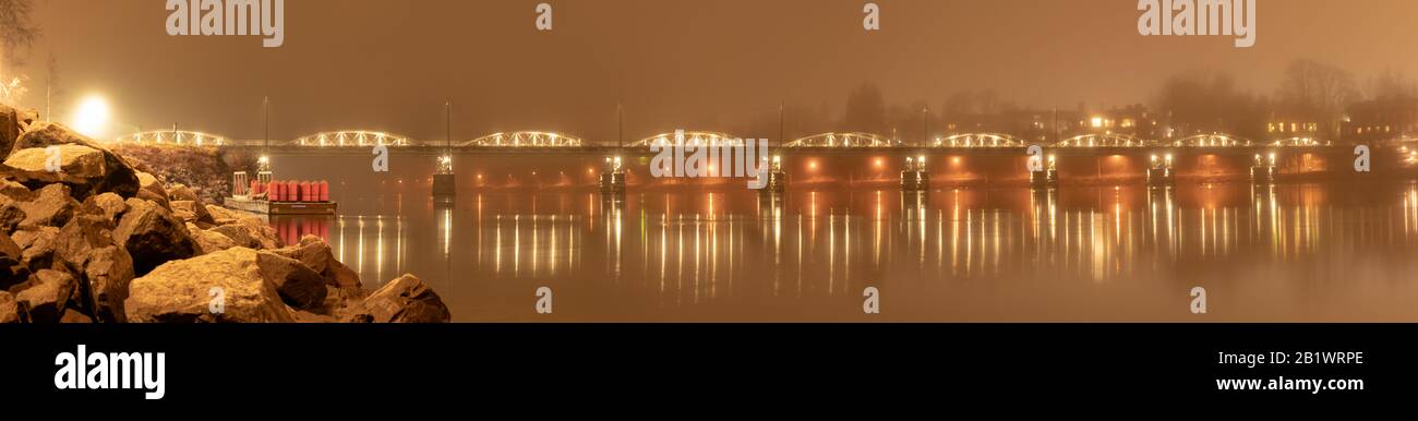 Night panorama, foggy view at the pedestrian bridge over the still Umea ...