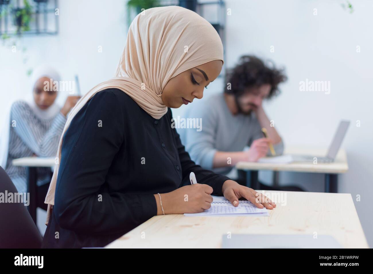 Group of multiethnic university students working on practice lessons ...
