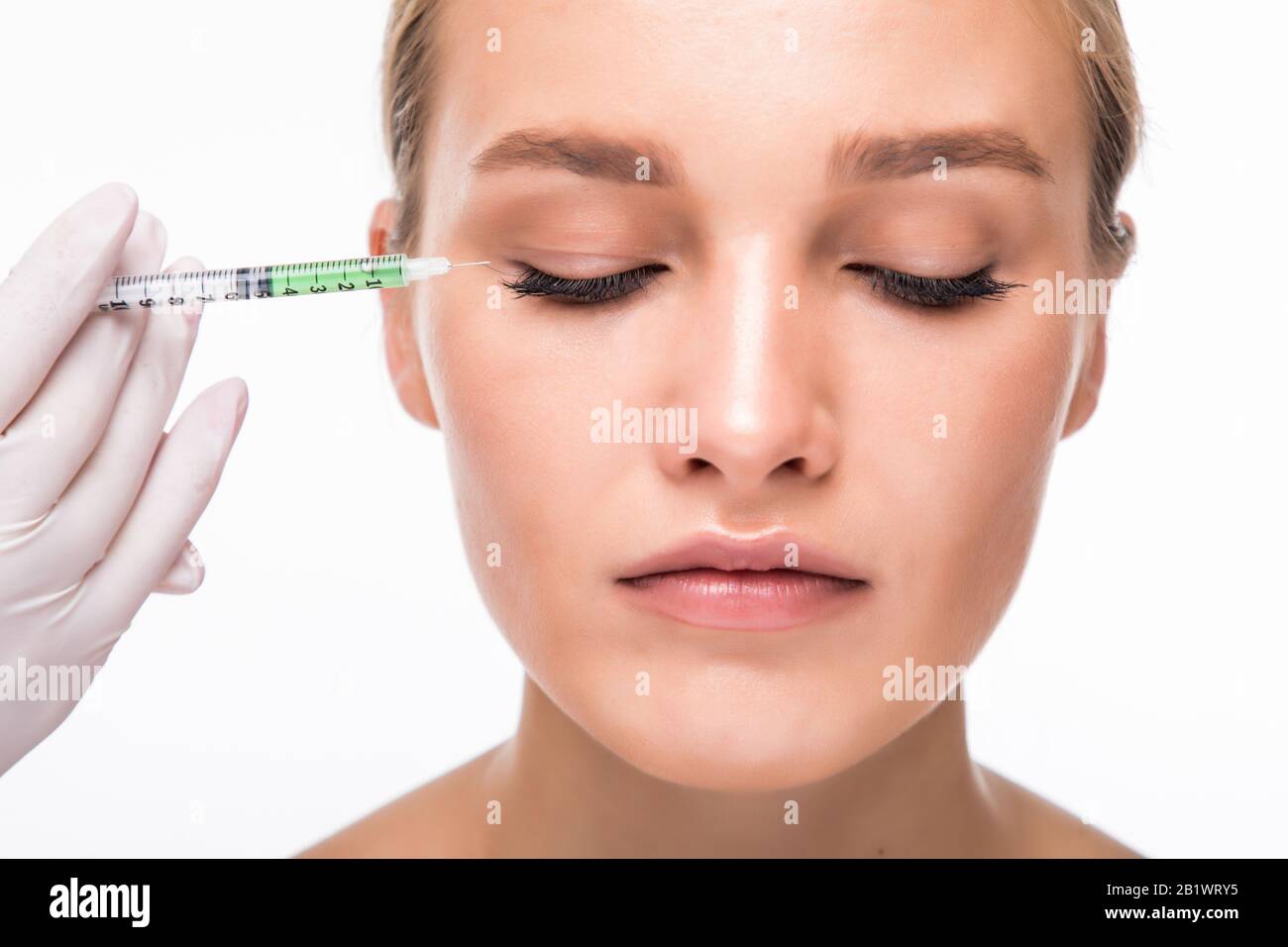Beautiful young woman gets beauty injection in eye area from sergeant ...