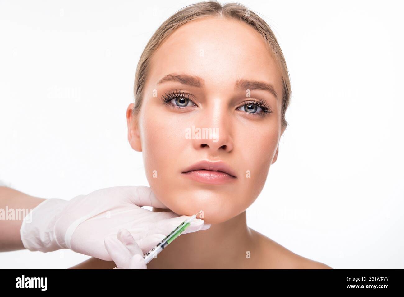 Beautiful young woman gets beauty injection in eye area from sergeant ...